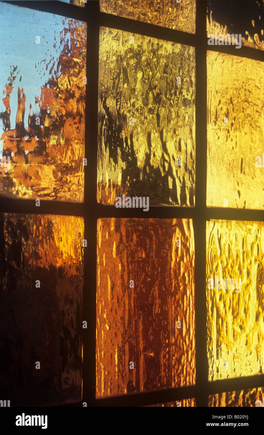 View through rectangular leaded textured window panes to an interior ...