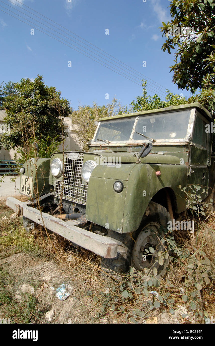 An abandoned old Land Rover basking in the sunshine in the traditional ...
