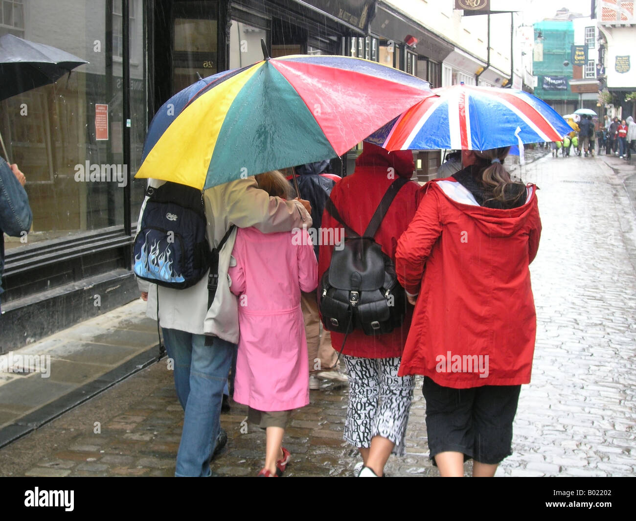seeking shelter from the rain under Union Jack umbrella (Canterbury ...