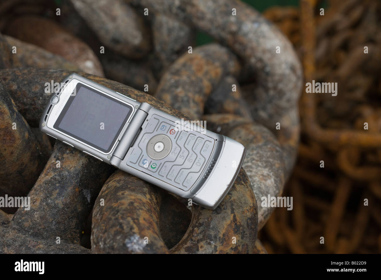 Mobile phone resting on pile of rusty chains Stock Photo - Alamy