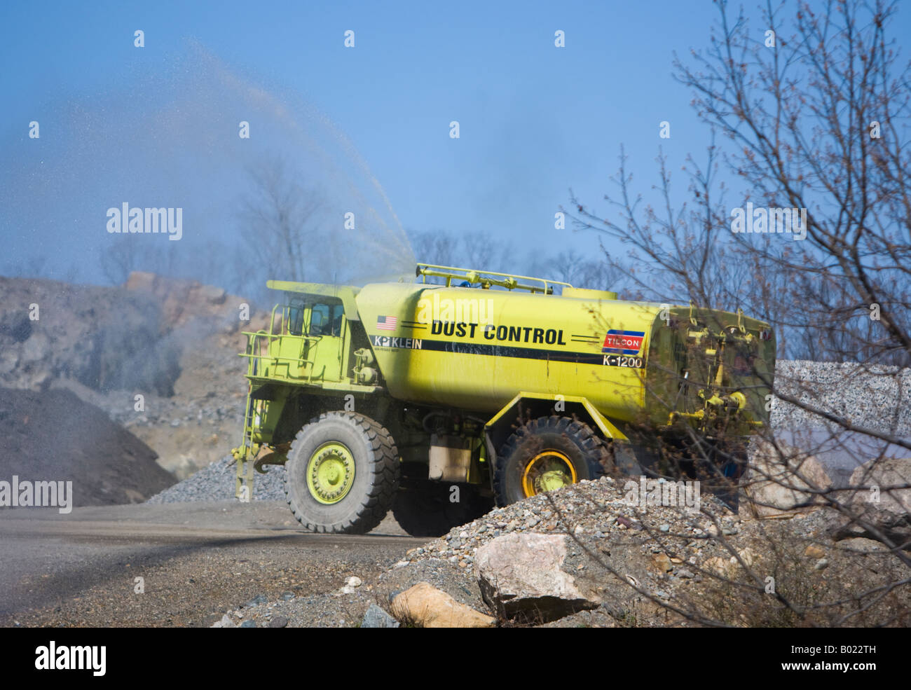 Dust control truck at a building site Stock Photo - Alamy
