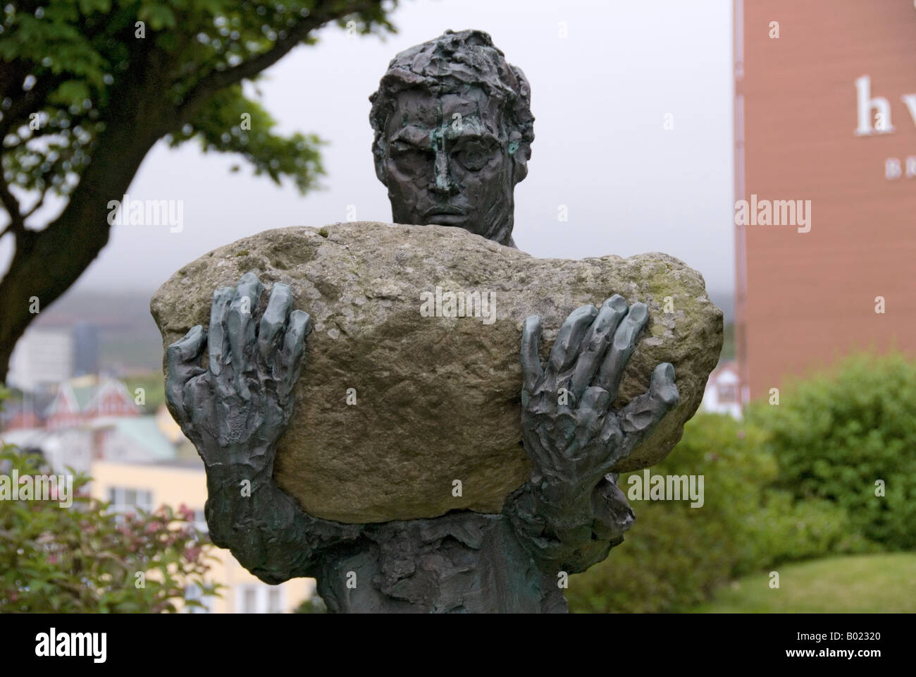 Sculpture of a man carrying a large rock, in Torshavn, Faroe Islands ...