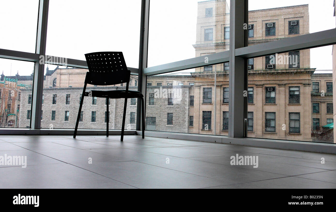 Empty chair sitting in-front of window Stock Photo - Alamy