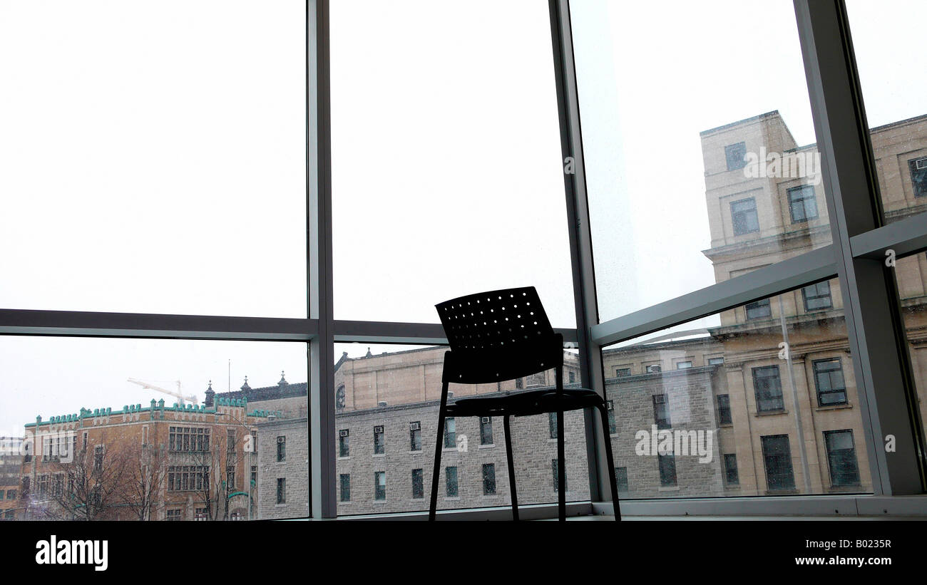 Empty chair sitting in-front of window Stock Photo - Alamy