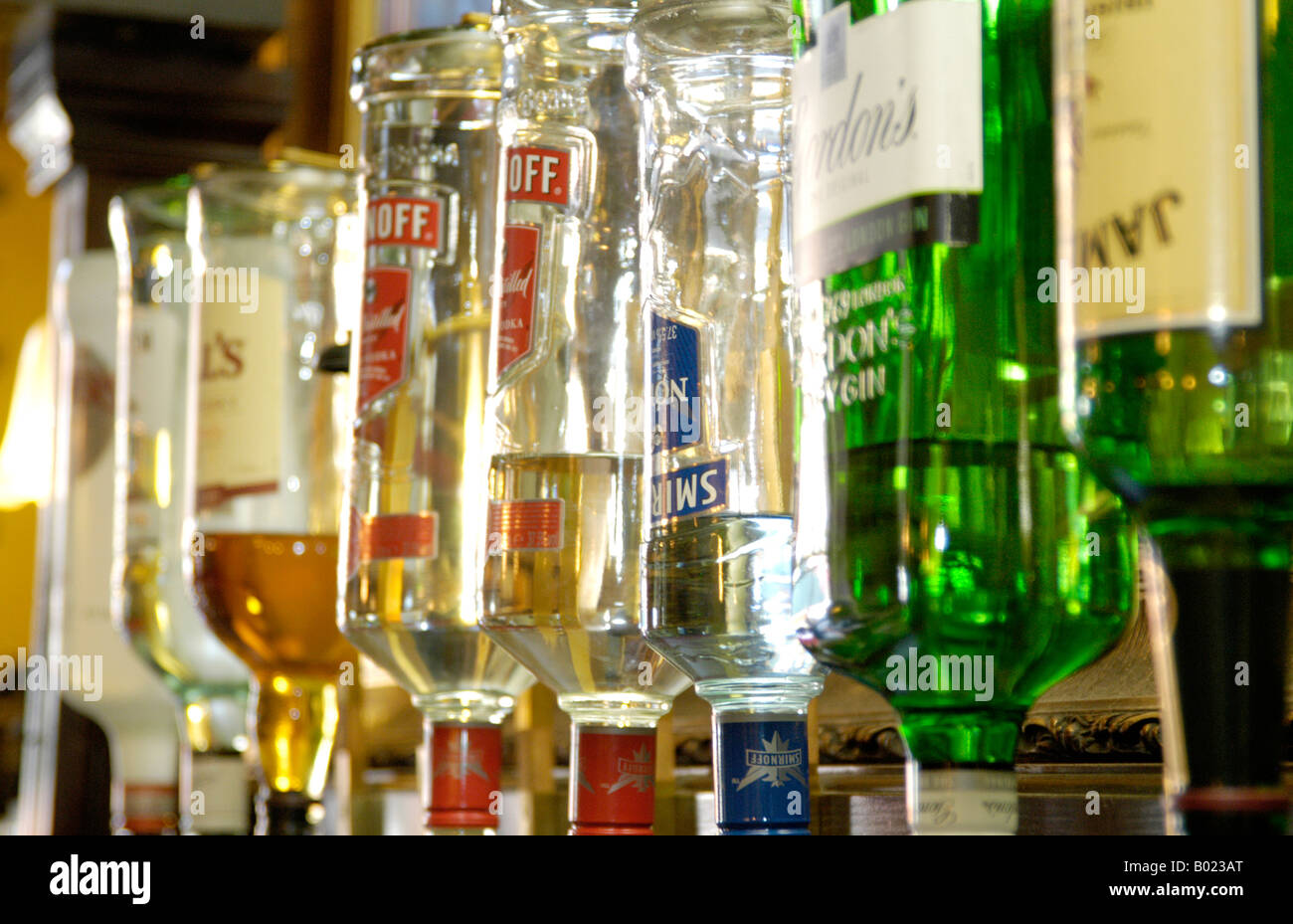 Row of spirit bottles in a bar Stock Photo - Alamy