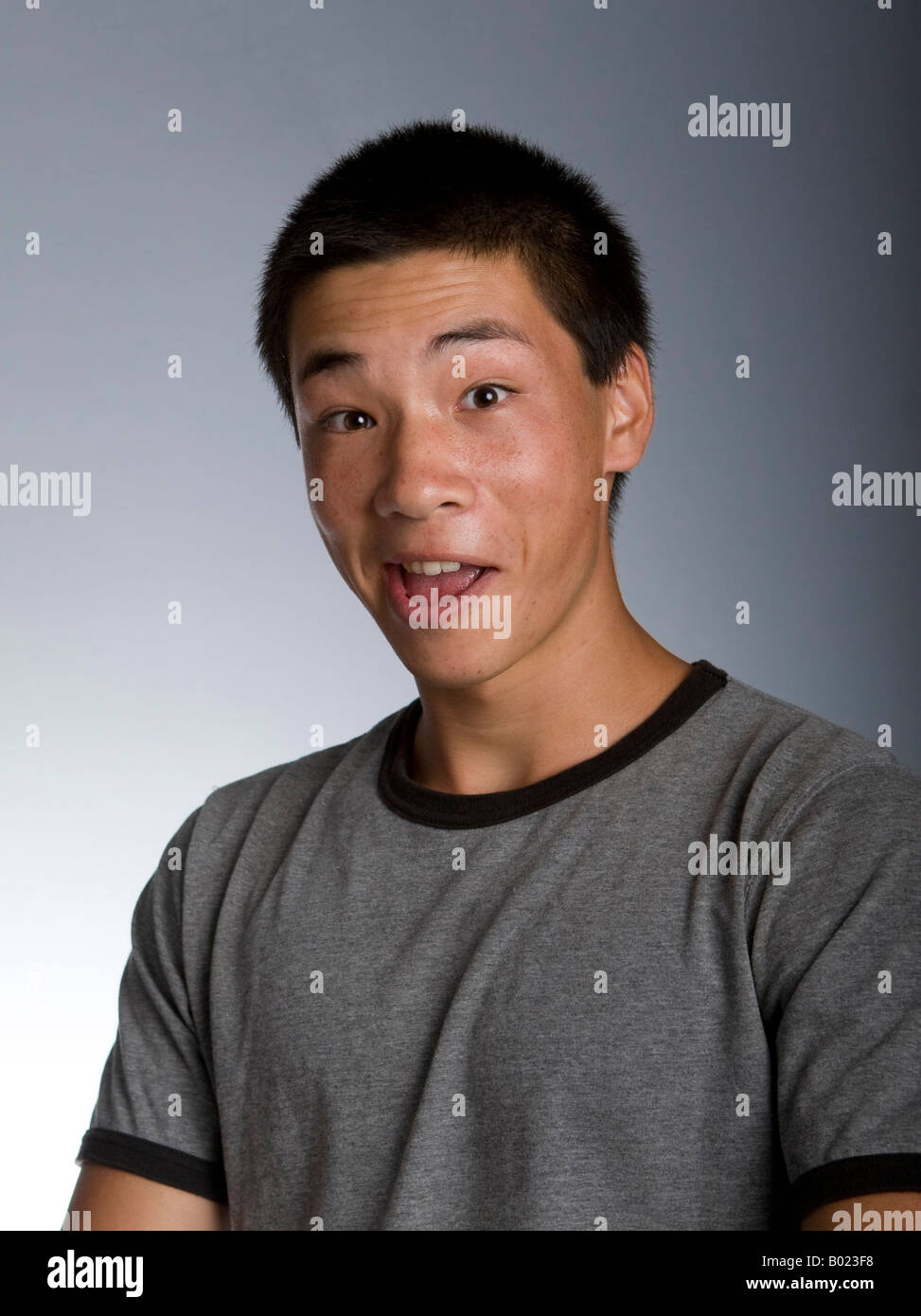 Studio portrait of teenage ethnic male with a goofy facial expression ...