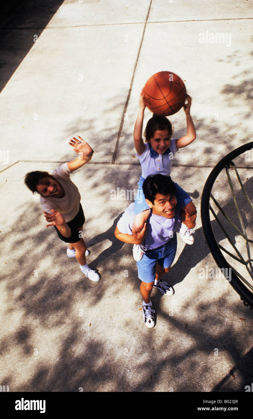 Kids Playing Basketball Outside In Driveway
