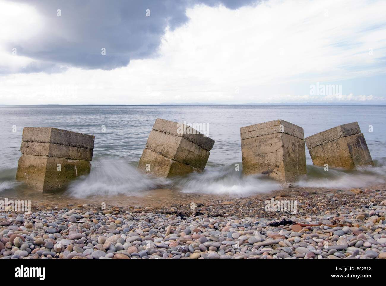 A long exposure of the waves between beach obstacles Stock Photo - Alamy