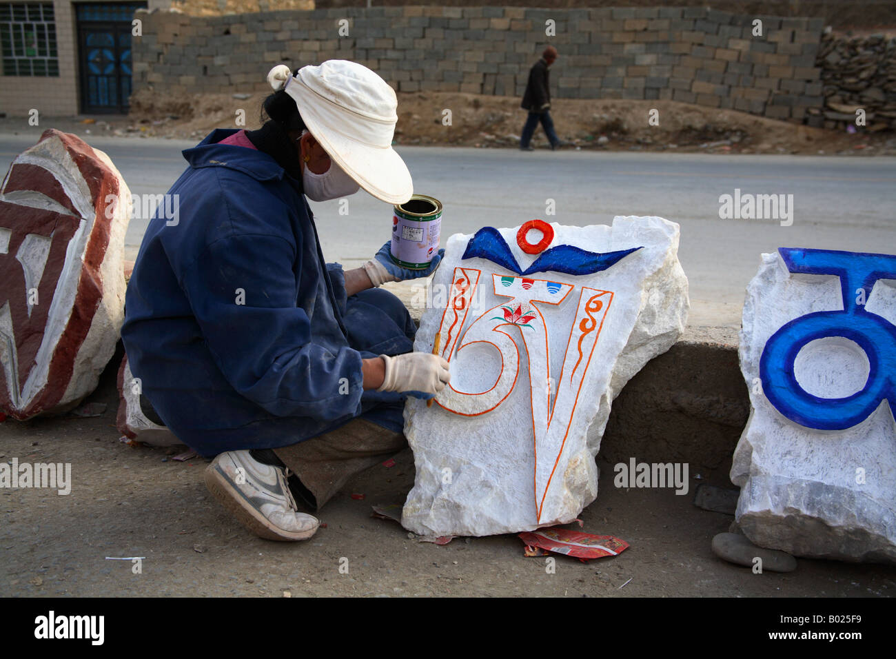 a painter of the Om Mani Padme Hum symbols Stock Photo - Alamy