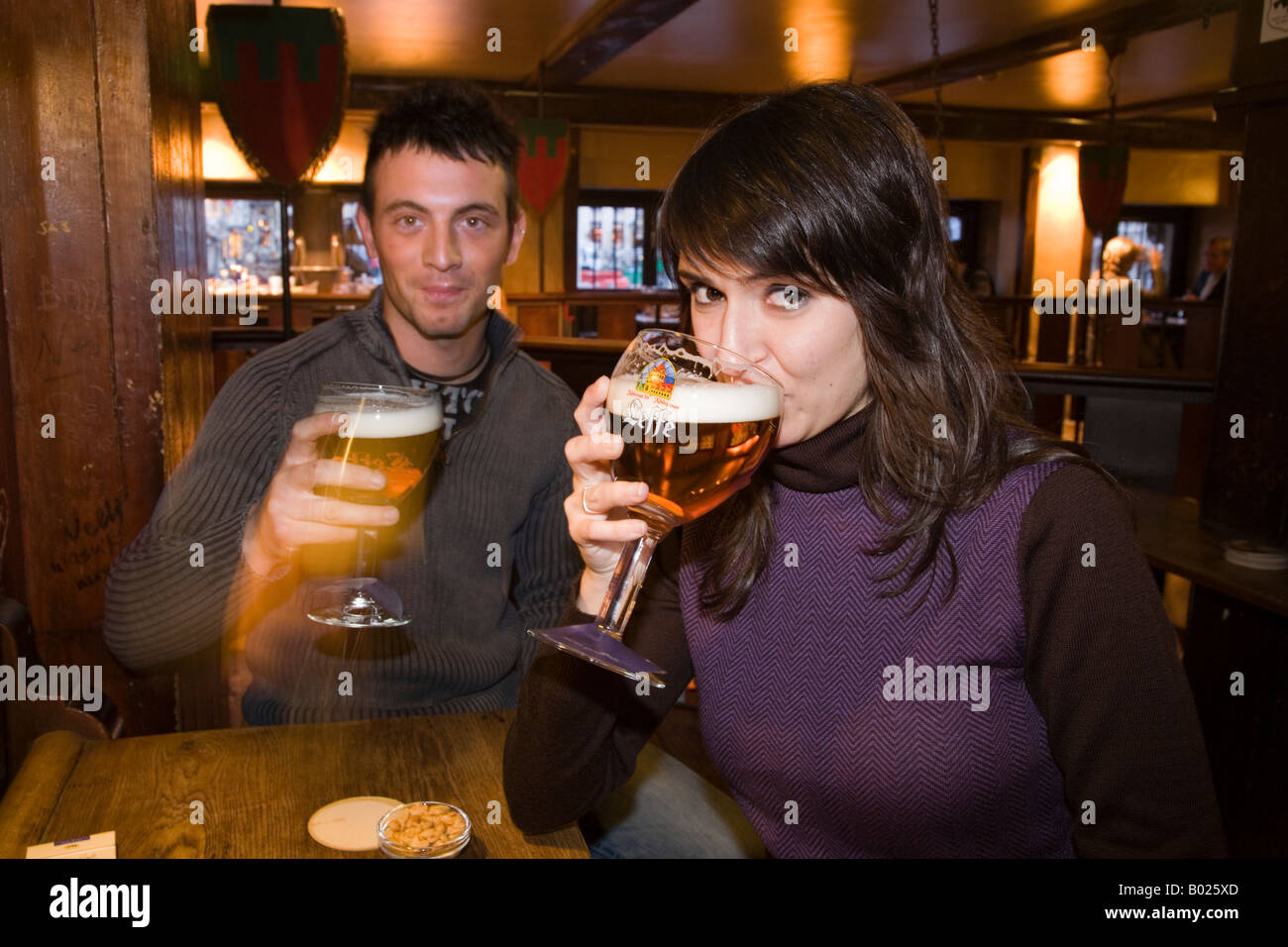 Young couple drink a Belgian beer in Le Roy d’Espagne bar. Grand Place ...