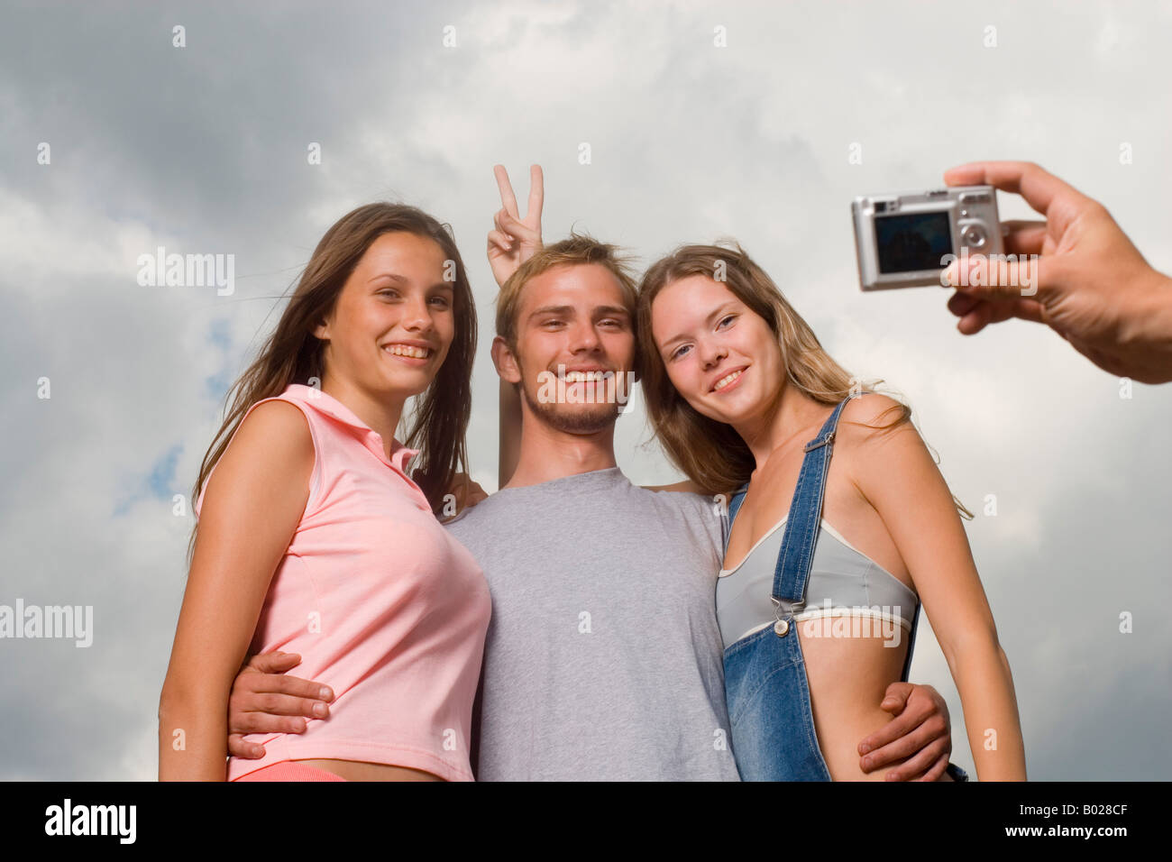group of three friends posing for a portrait Stock Photo - Alamy