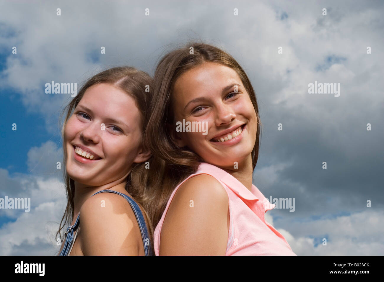 headshot of two smiling young women standing back to back Stock Photo ... headshot of two smiling young women standing back to back Stock Photo ...