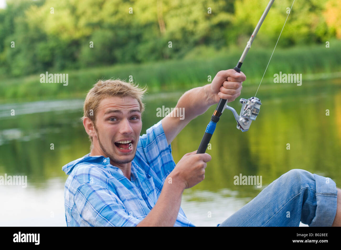 portrait of young man fishing Stock Photo - Alamy