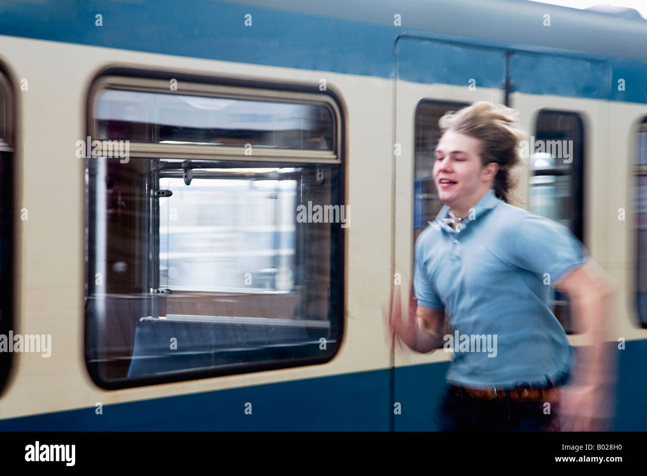 teenage boy running to catch underground train Stock Photo - Alamy