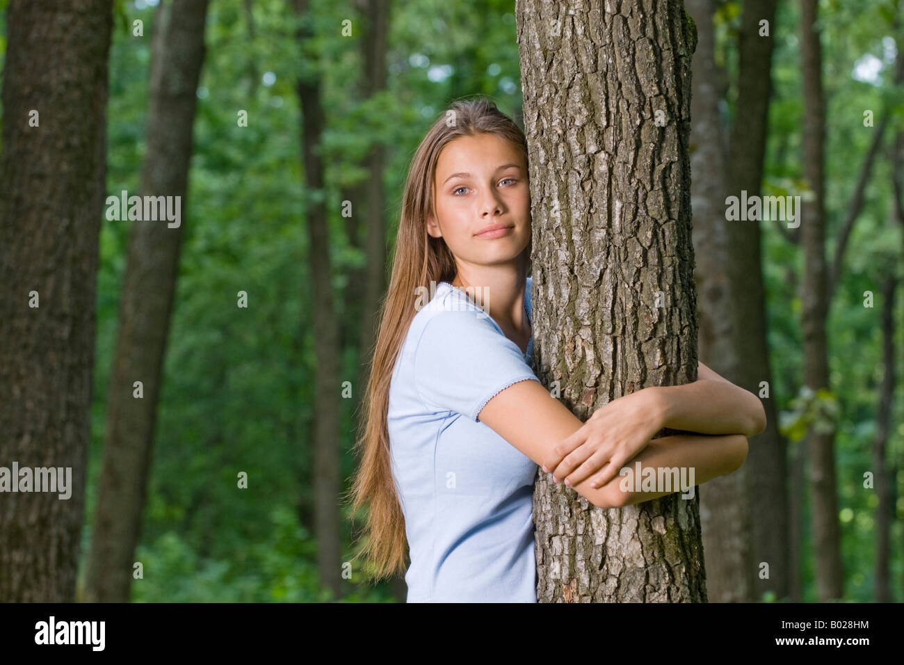 portrait of teenage girl hugging tree Stock Photo - Alamy