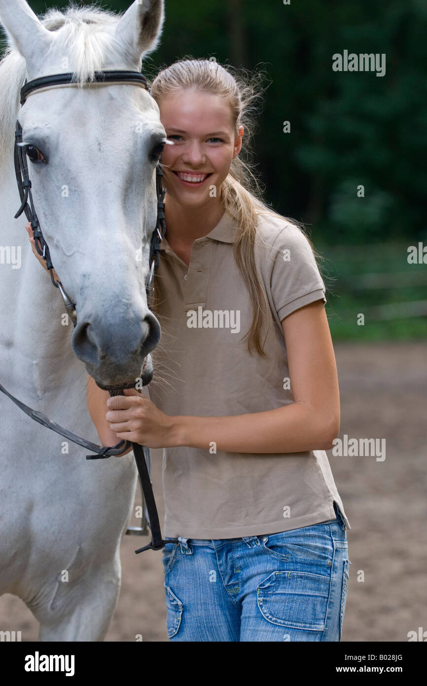 portrait of young woman with white horse Stock Photo - Alamy