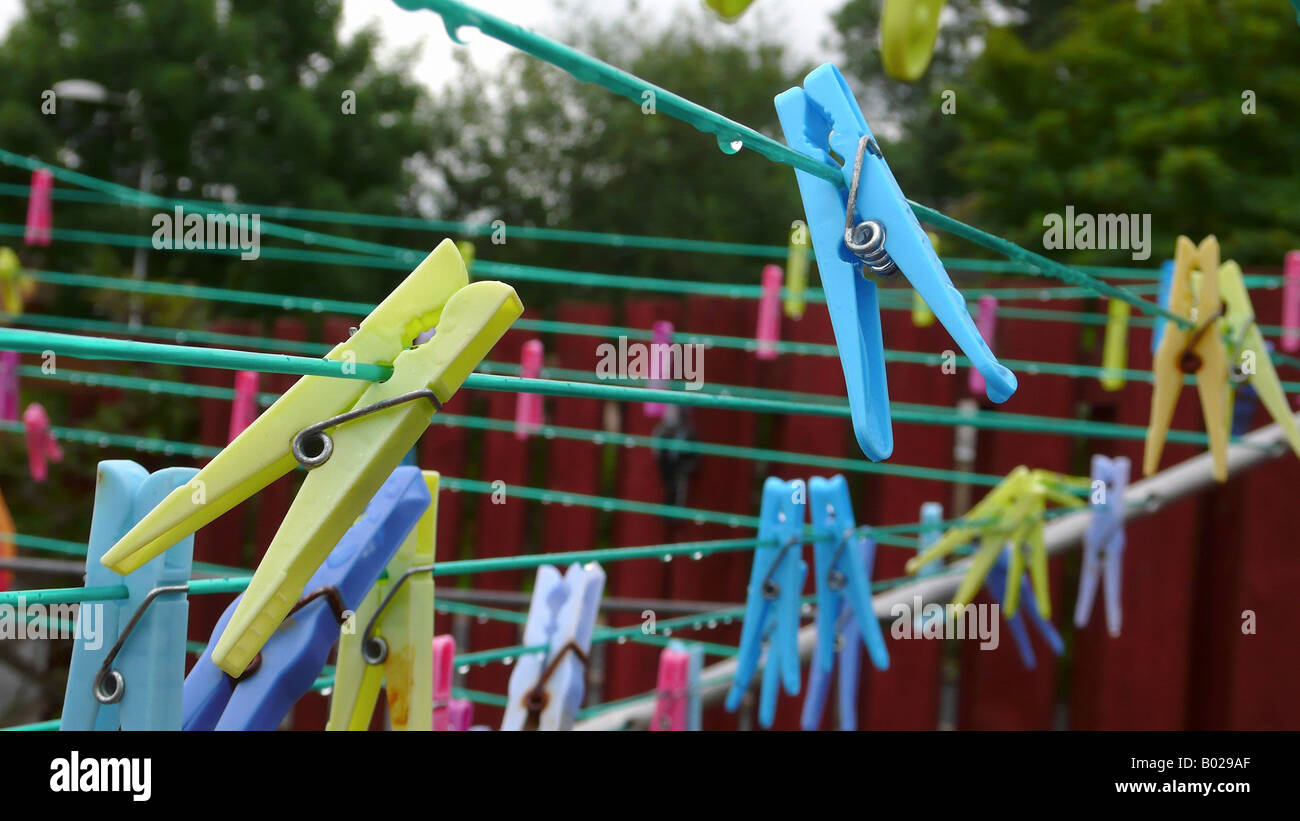 Multi-colored clothes pins on a laundry line Stock Photo - Alamy