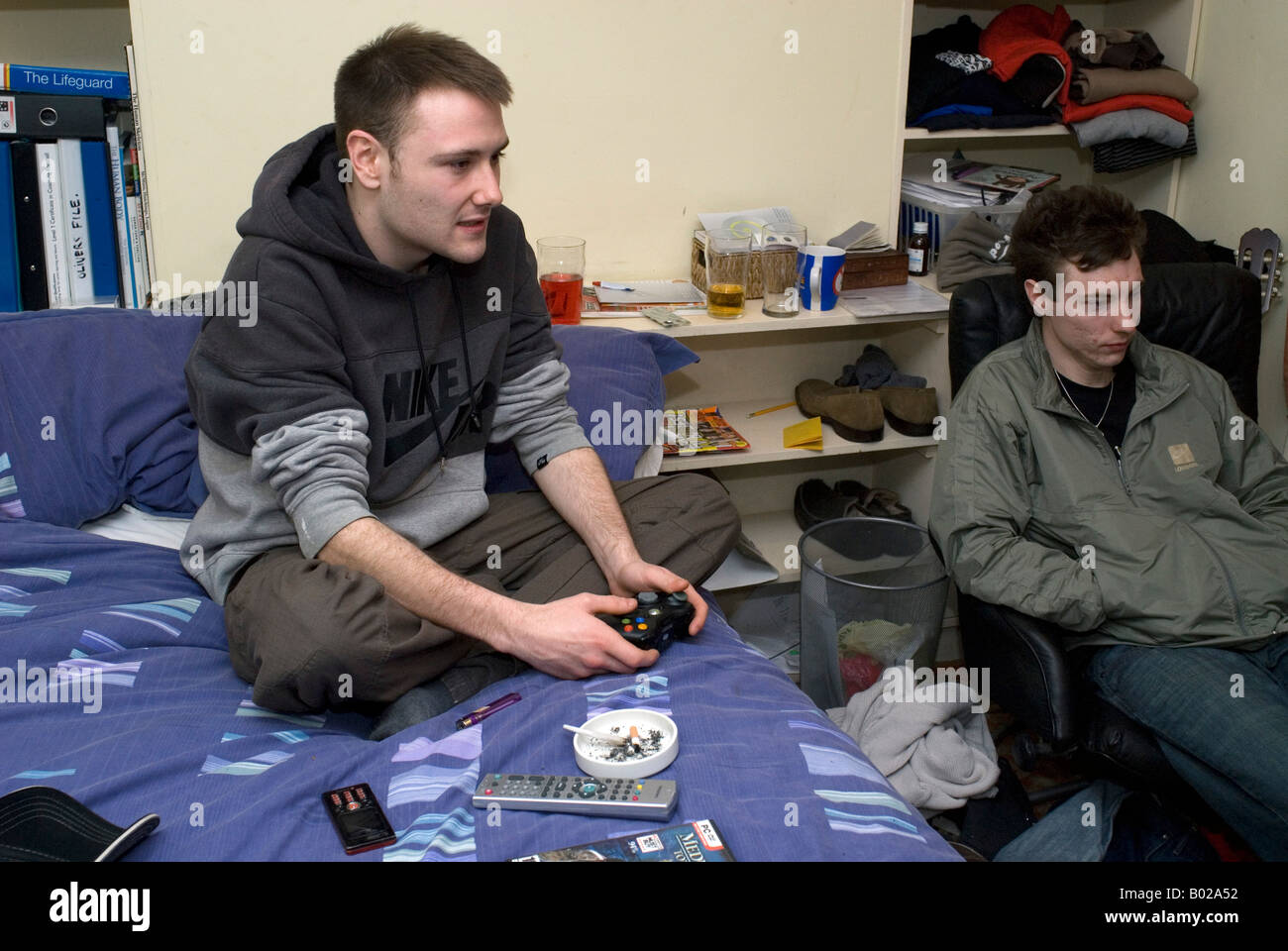 A young man playing a game on his XBox 360 Stock Photo - Alamy