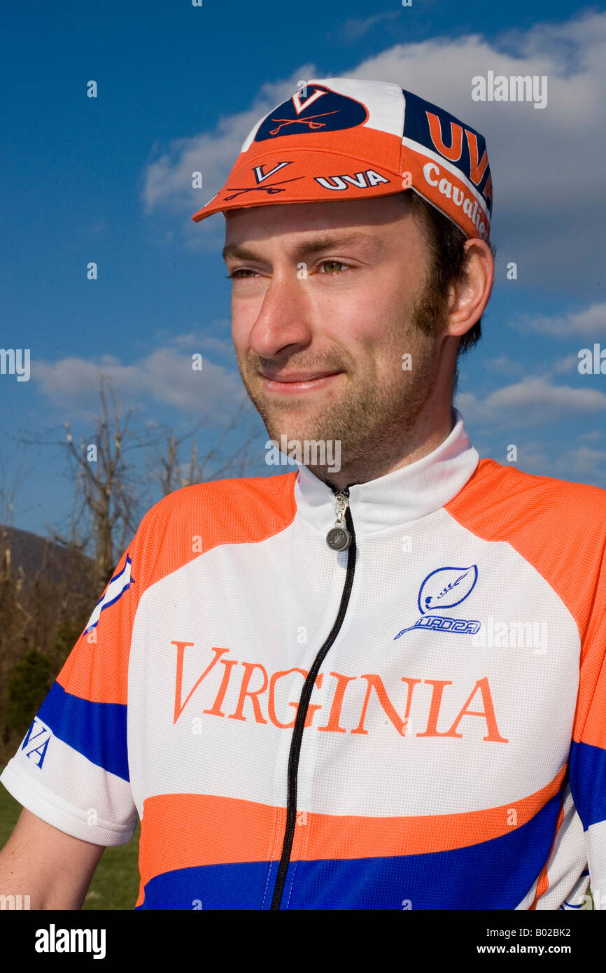 Portrait of a college aged young male cyclist in team uniform with ...