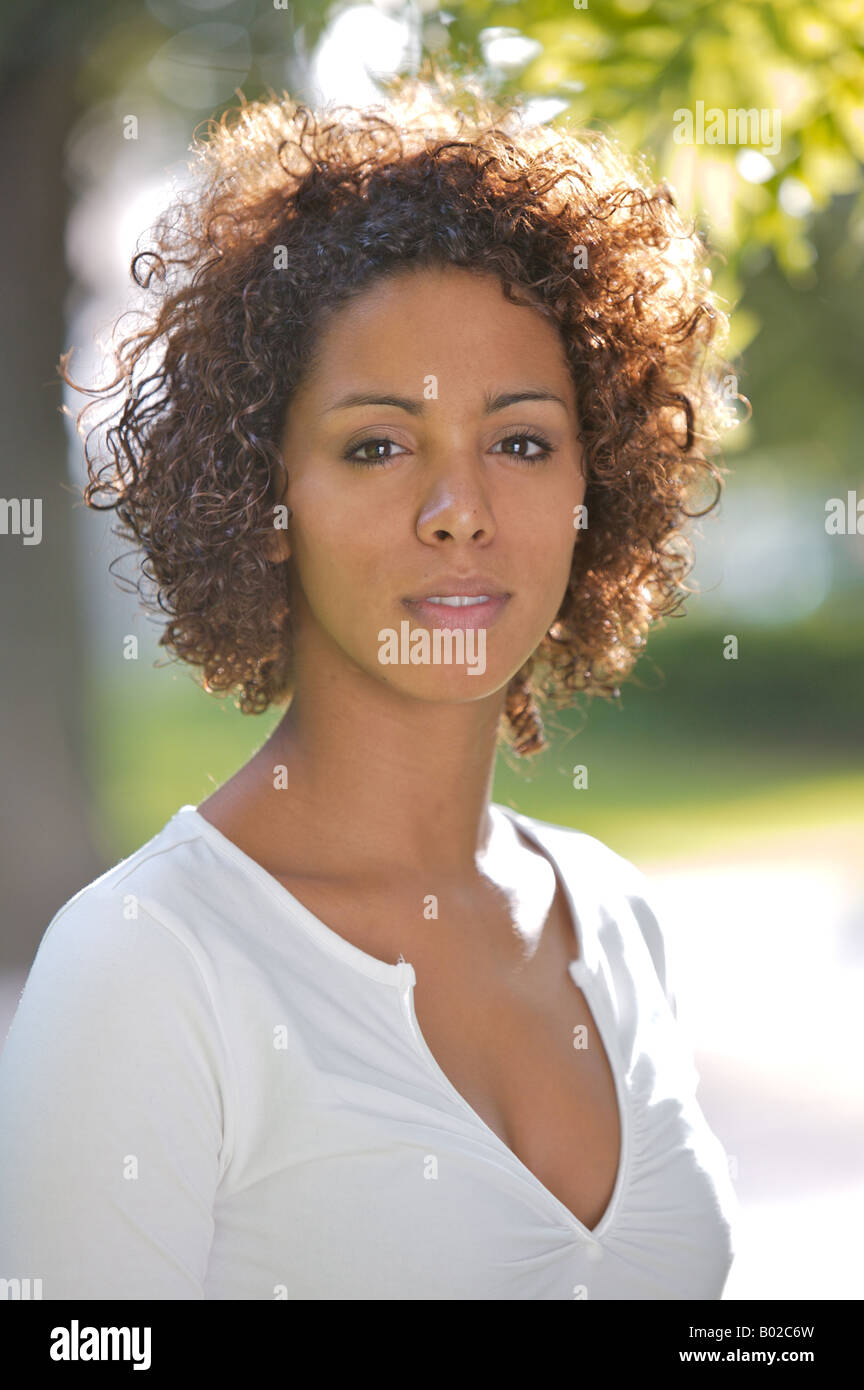 Young African mulata woman - half German half Cuban - in a park Stock ...