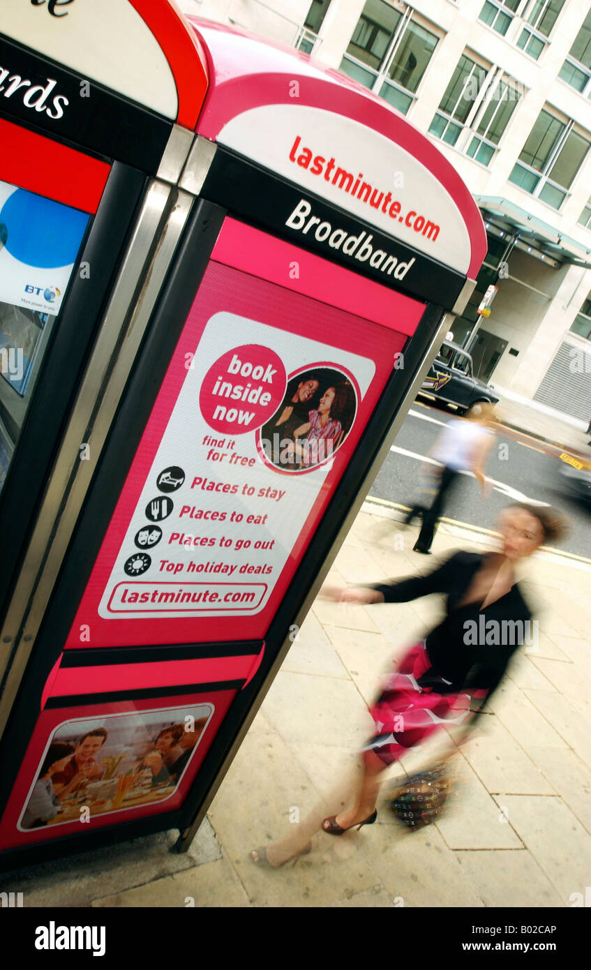 Woman entering phone and internet booth Stock Photo - Alamy