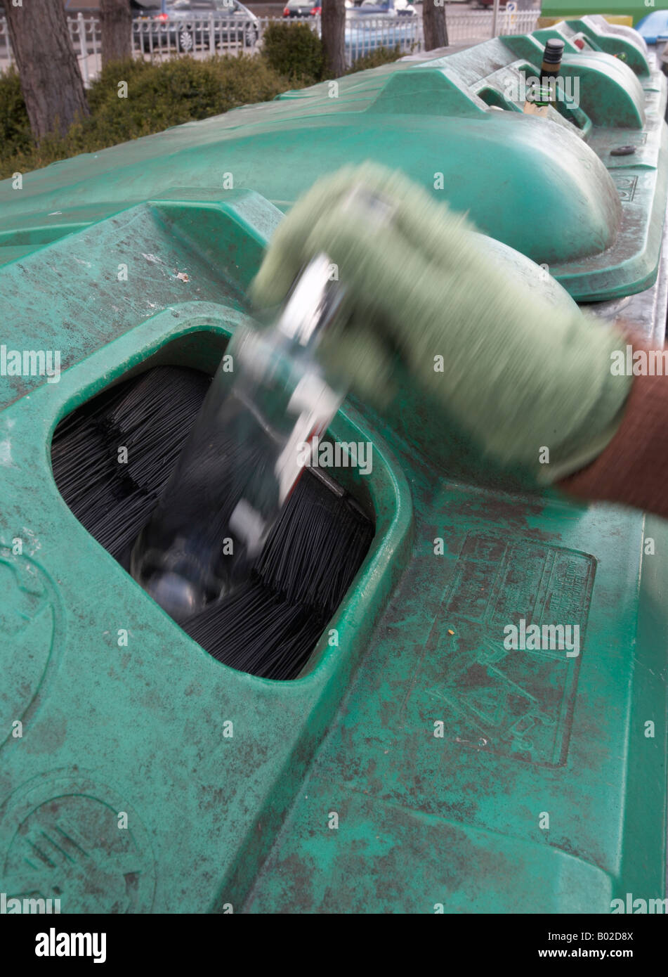 Woman recycling glass at a bottle bank (mixed glass Stock Photo - Alamy