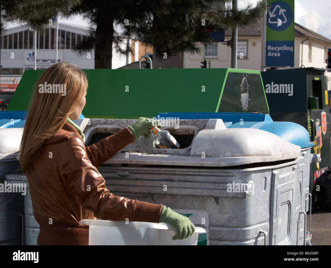 Woman recycling glass at a bottle bank Stock Photo - Alamy