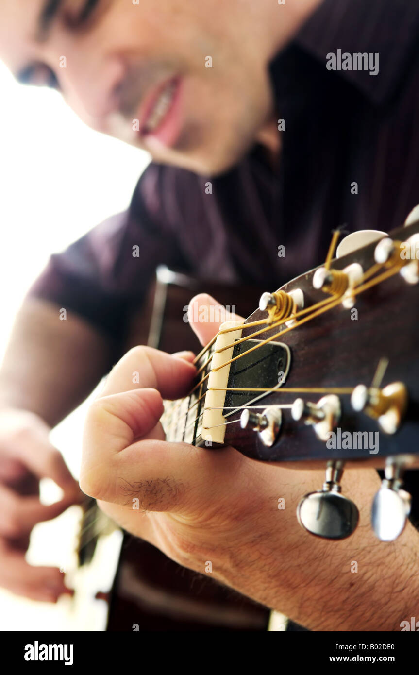 Man playing a musical instrument acoustic guitar Stock Photo - Alamy