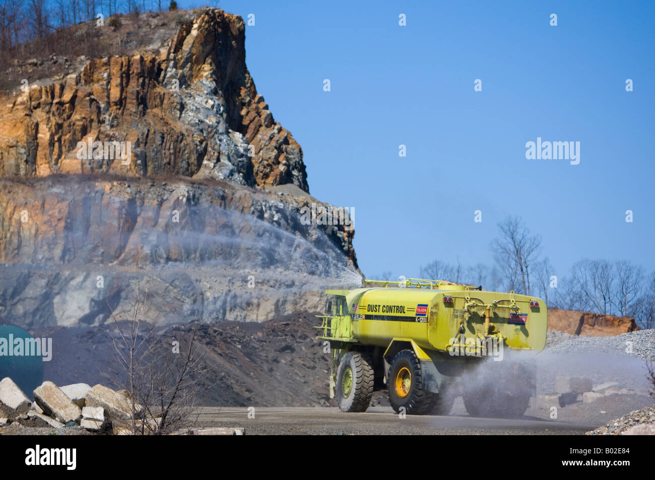 Dust control truck at a building site Stock Photo - Alamy