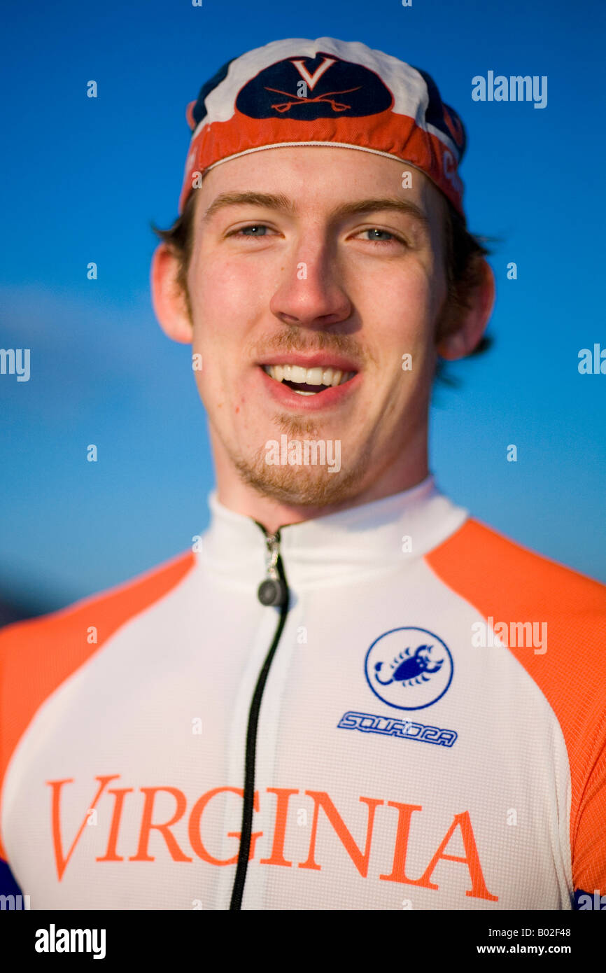 College aged young male cyclist portrait in team kit jersey with blue ...