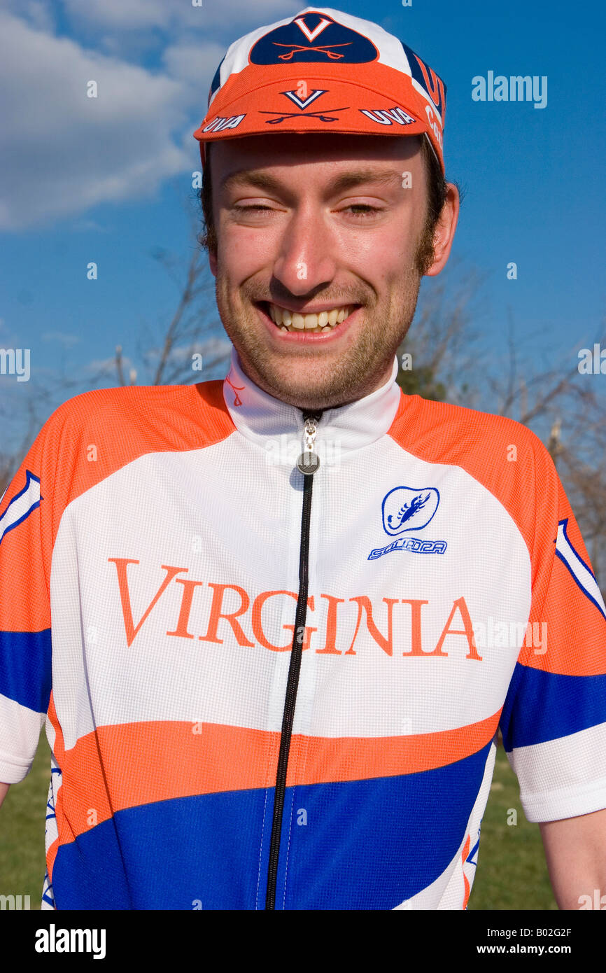 Portrait of a college aged young male cyclist in team uniform with ...