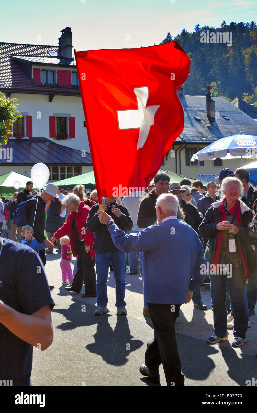 A Swiss flag-thrower parading his flag through the crowds at a 'desalpe ...
