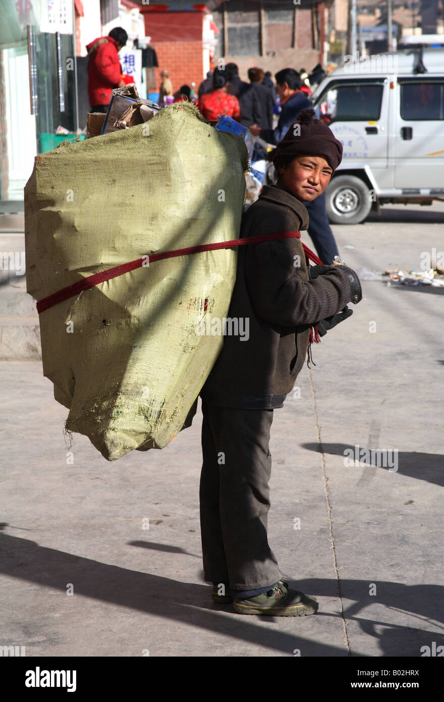 young boy collecting plastic bottles ,China Stock Photo - Alamy