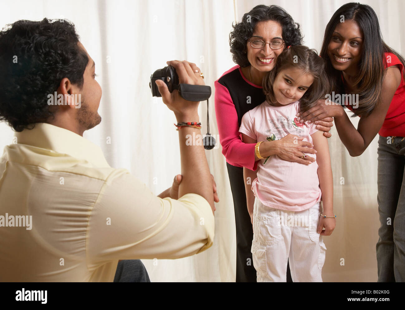 Indian father video recording family Stock Photo - Alamy