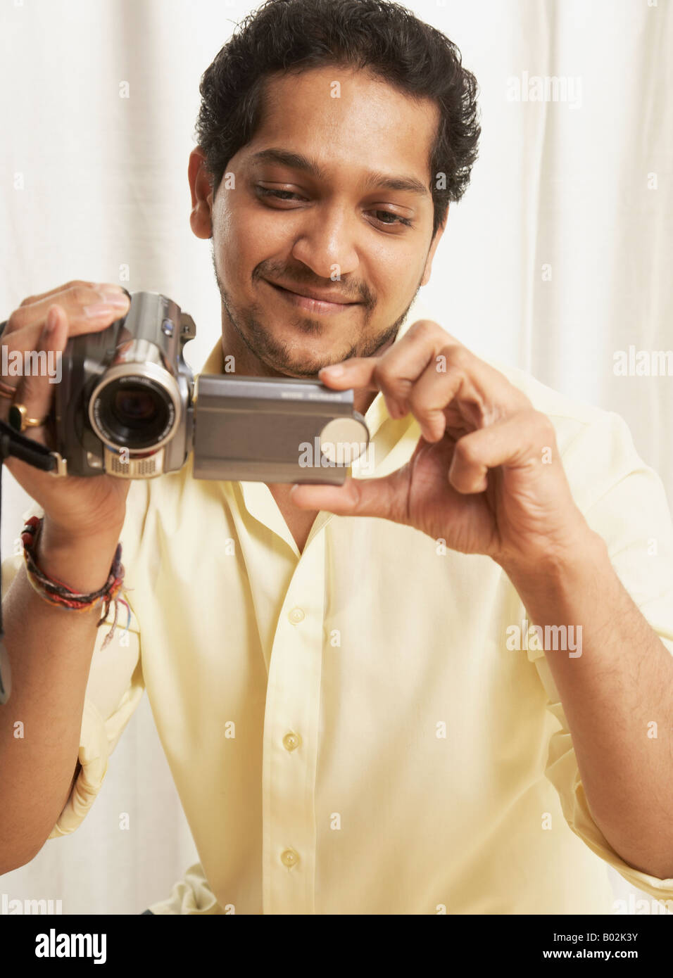 Indian man holding video camera Stock Photo - Alamy