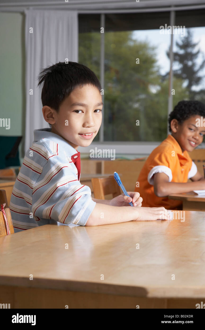 Multi-ethnic boys in classroom Stock Photo - Alamy