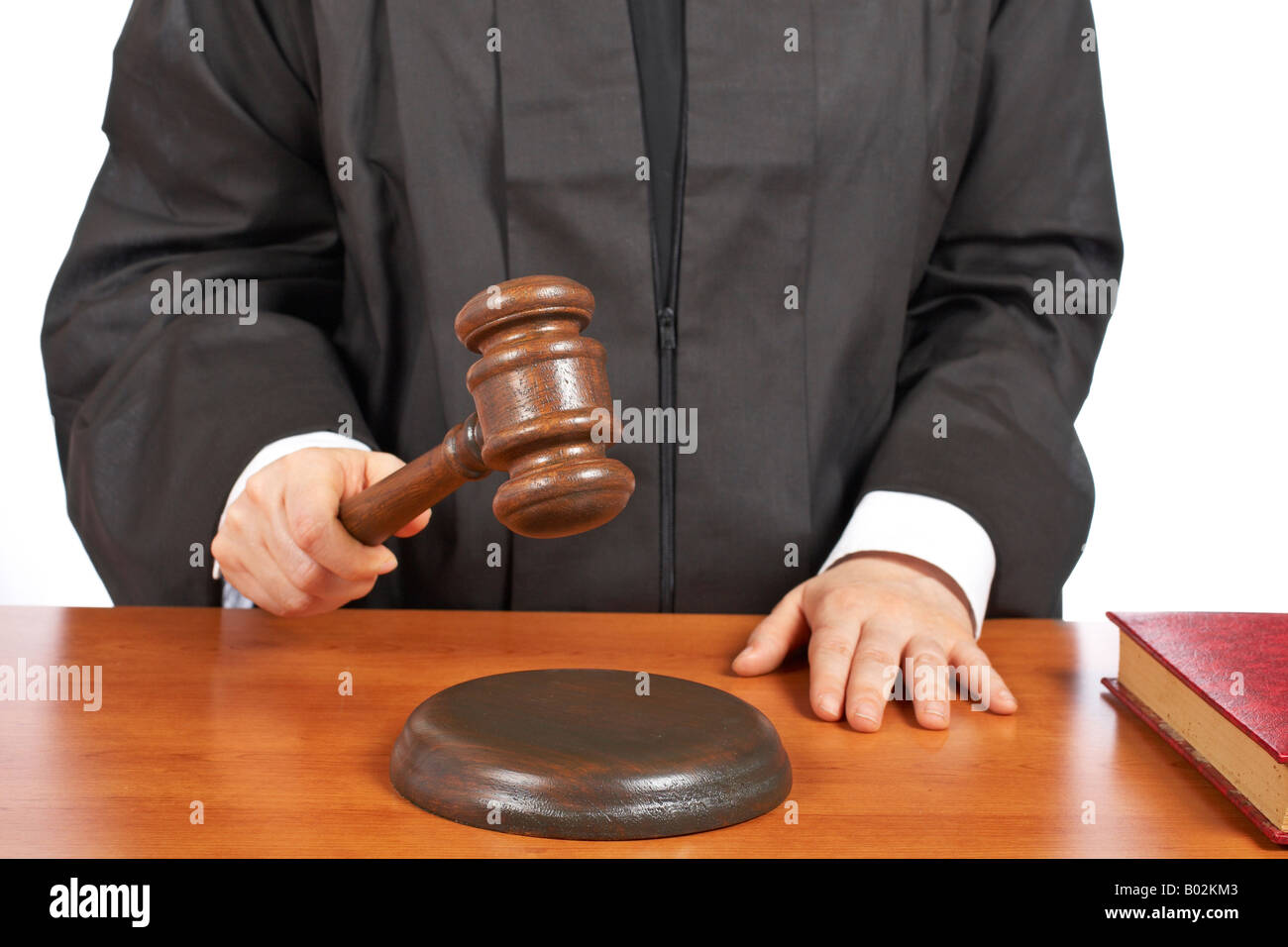 A female judge in a courtroom striking the gavel Shallow depth of field ...