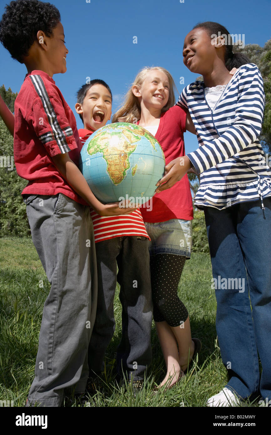 Multi ethnic children holding globe hi-res stock photography and images ...
