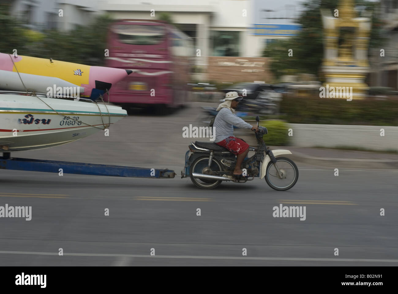 Moped towing a motorboat Stock Photo - Alamy
