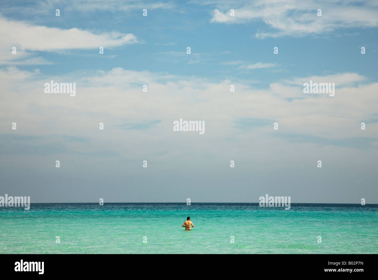 a man is entering in the sea water Stock Photo - Alamy