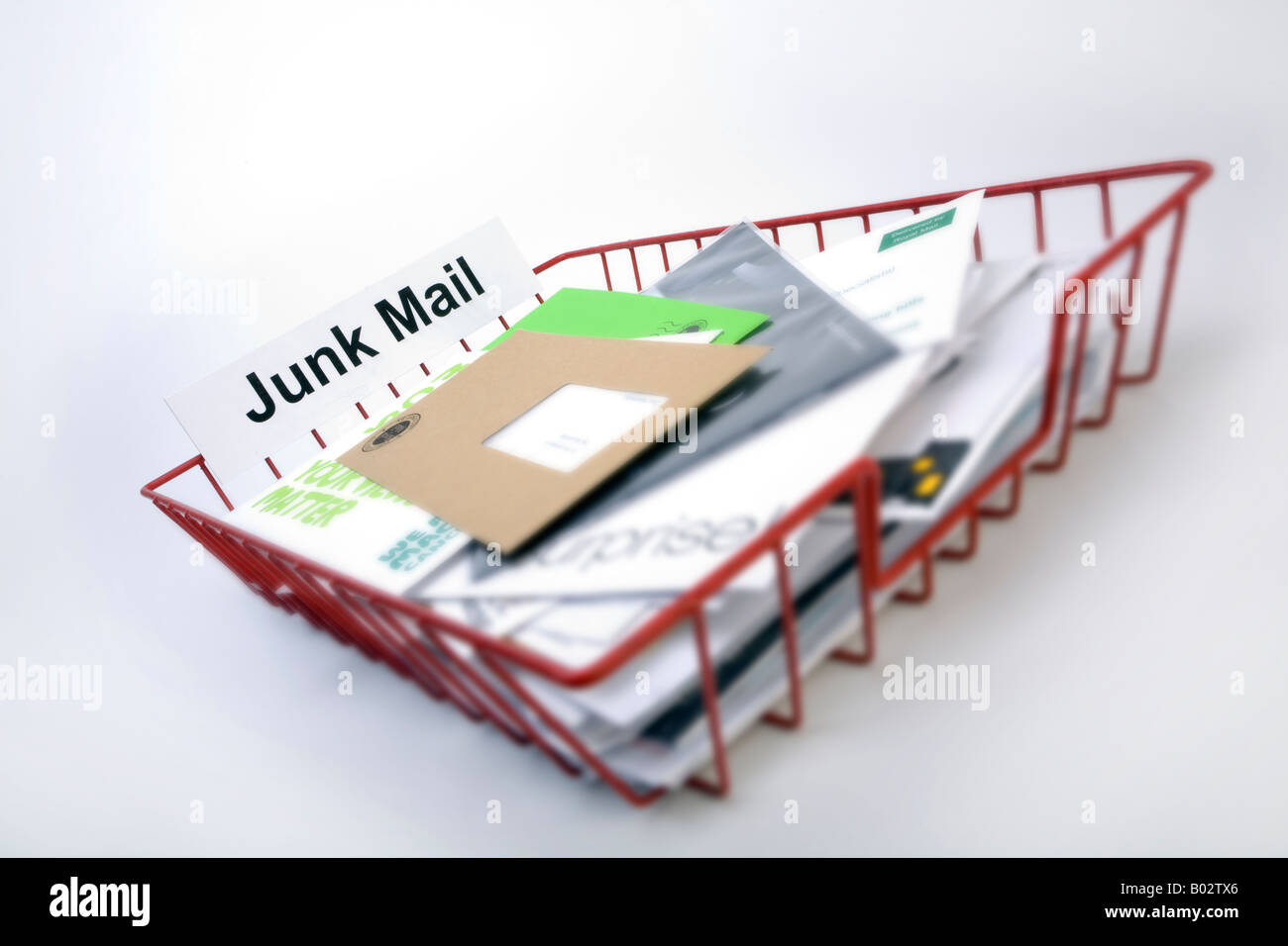 red wire mesh office post tray full of junk mail Stock Photo - Alamy