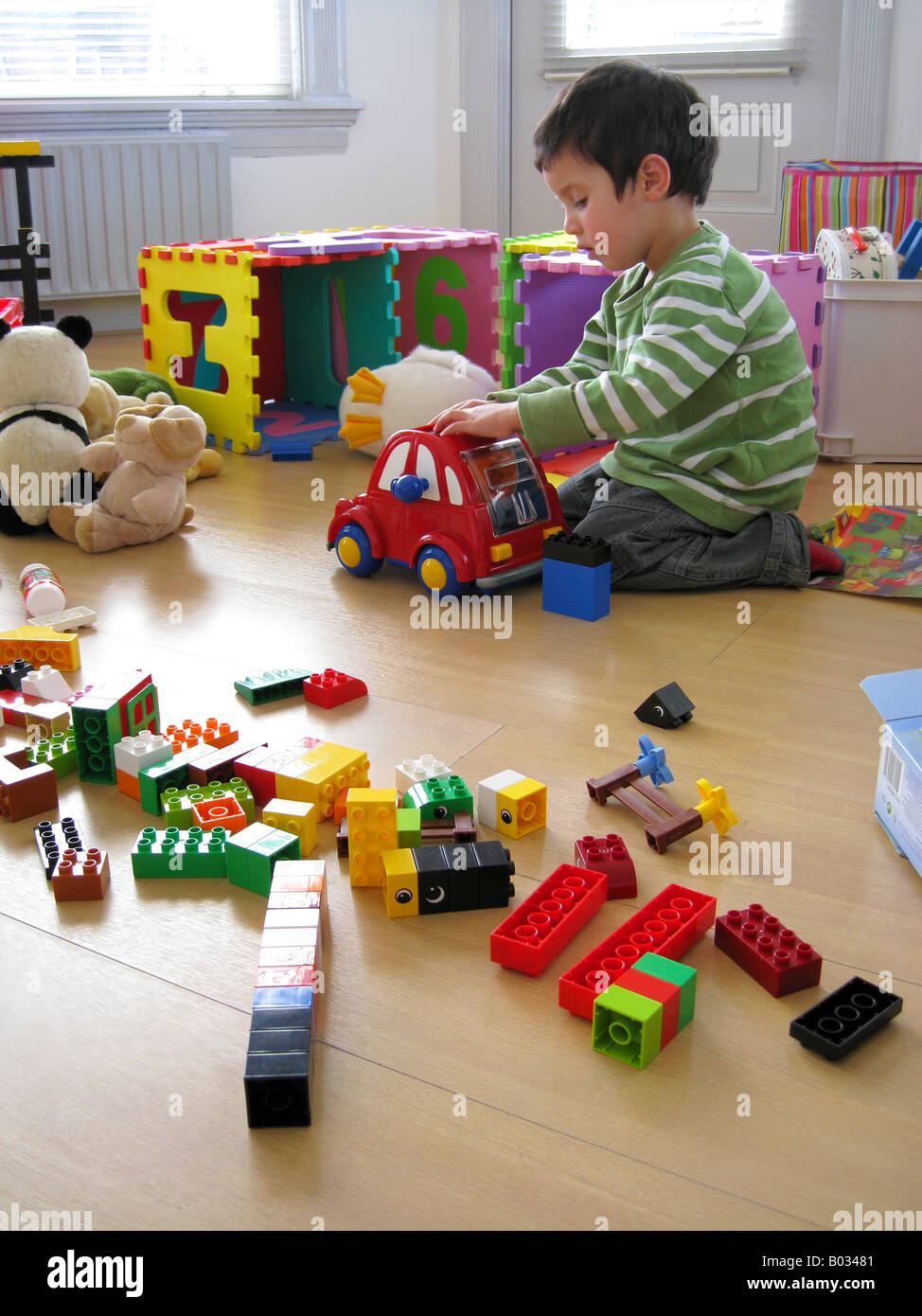 Little boy is playing with toys Stock Photo - Alamy