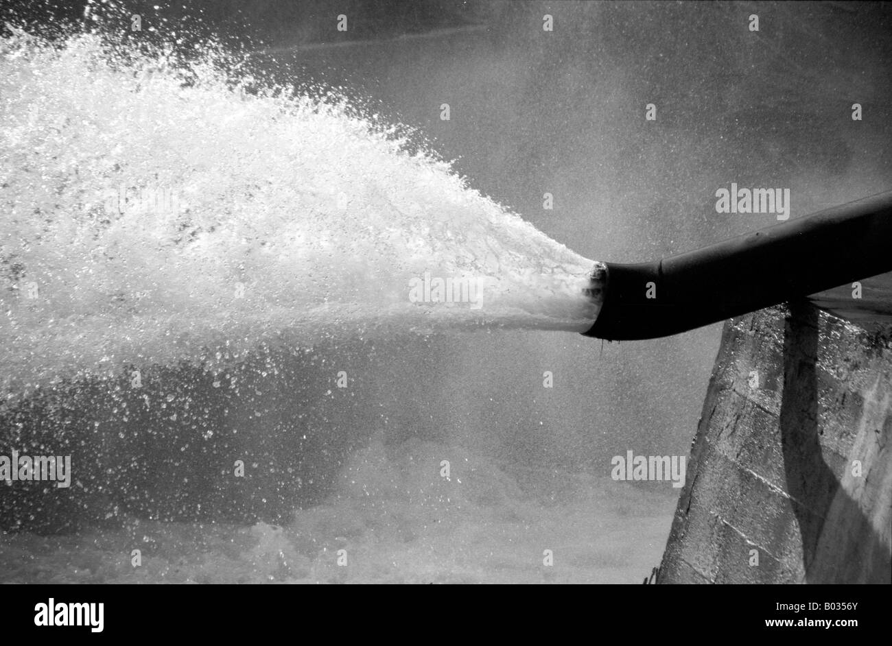 A runoff water pipe spurts water at a small dam in Kearney, Nebraska ...