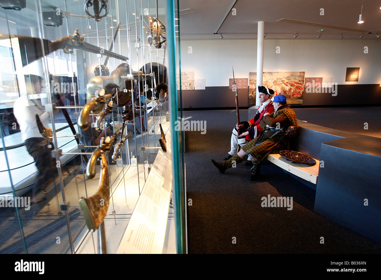 men dressed up as a red coat government soldier and a jacobite clansman ...