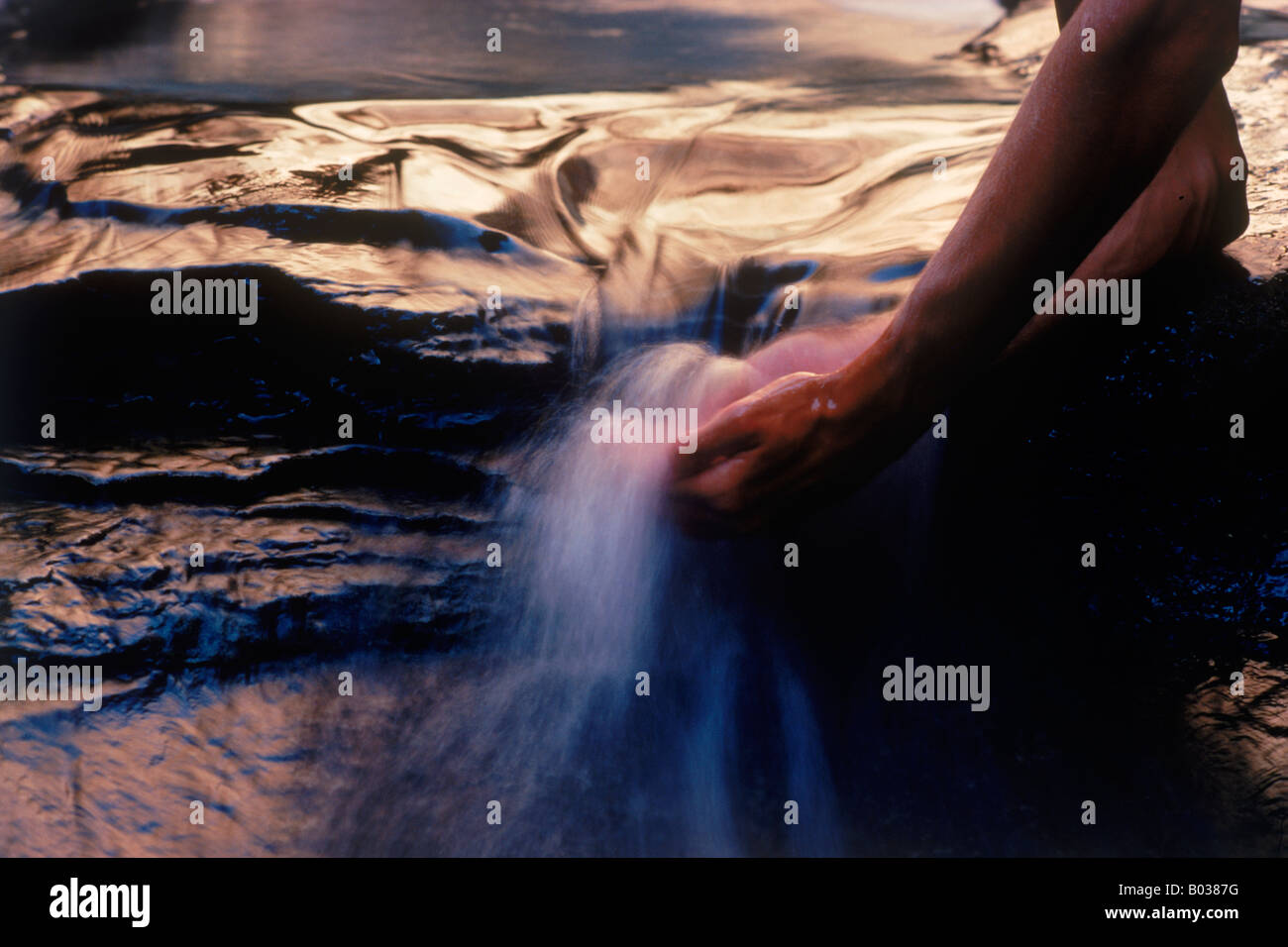 Hands holding stream water reflecting inner walls of Grand Canyon Stock ...