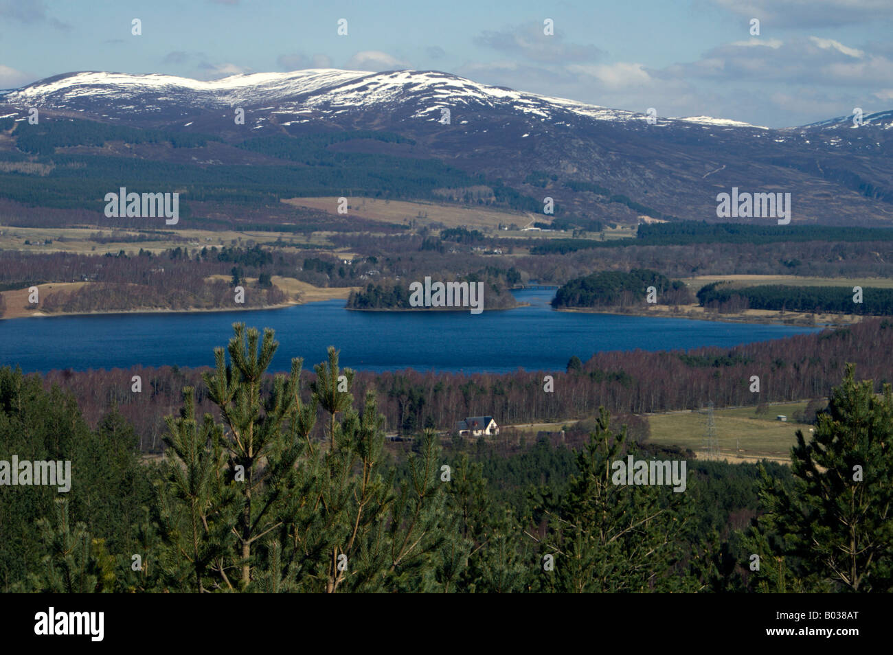 Uath Lochan, a tree-lined Scottish loch (lake) with mountains in the ...