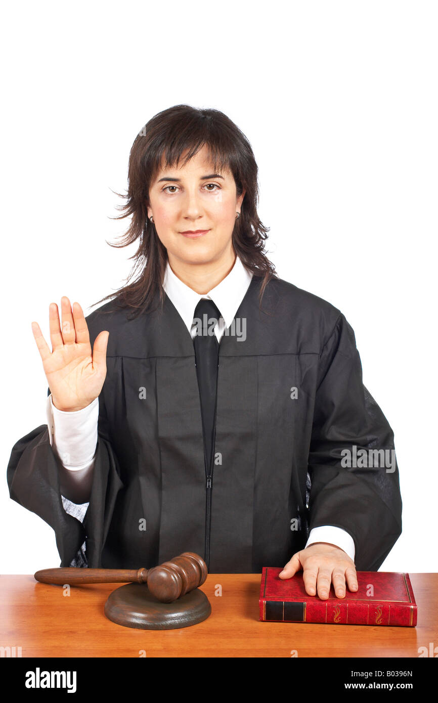 A female judge taking oath in a courtroom isolated on white background ...