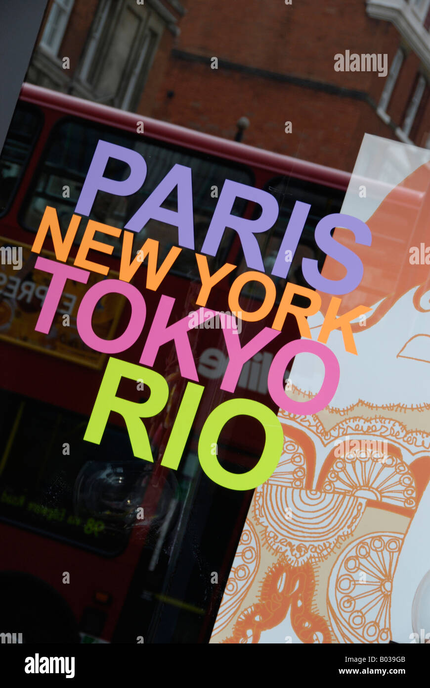 Sign on fashion shop window reading Paris New York Tokyo Rio outside ...