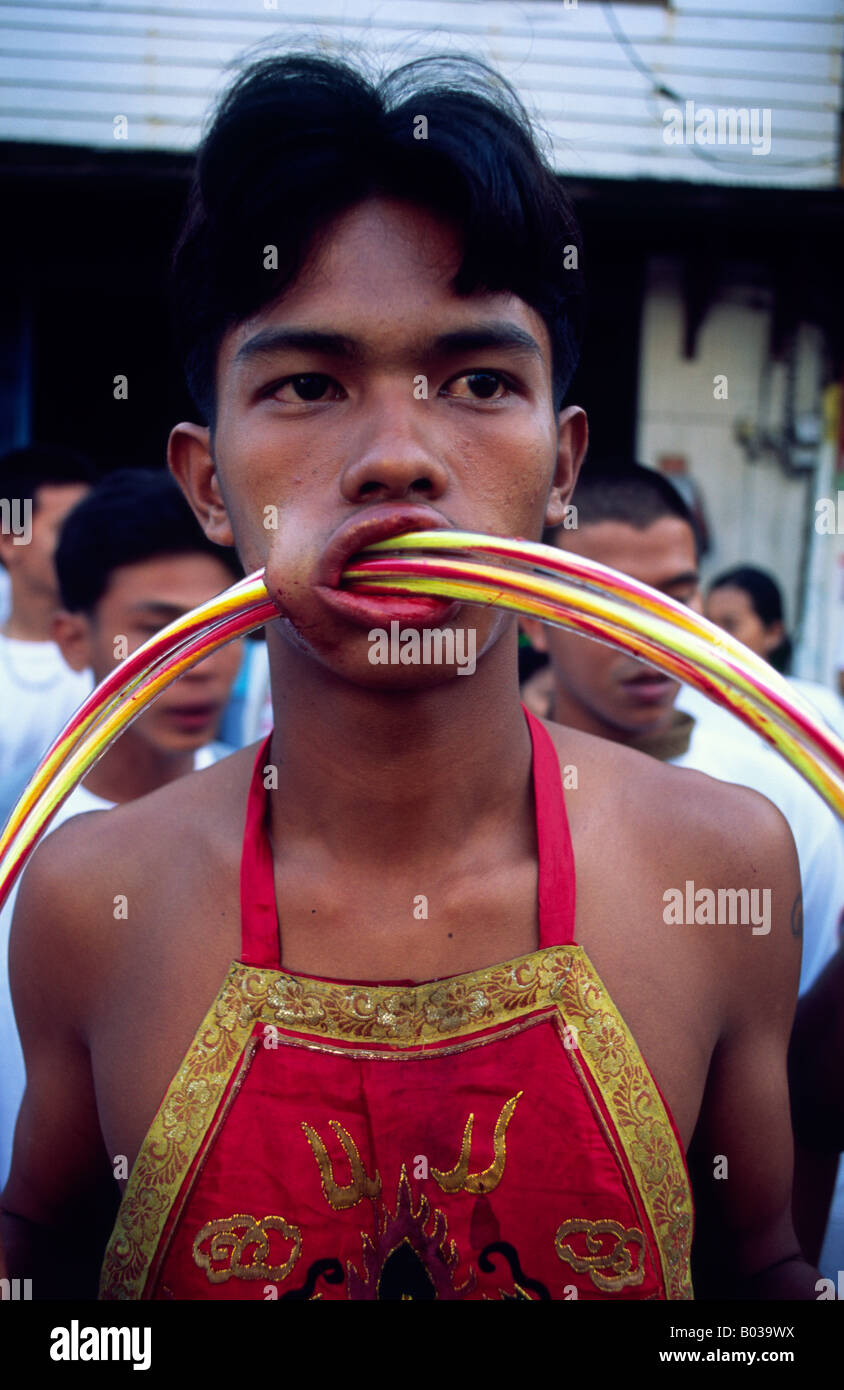 A man with two hula hoops inserted trough his face Stock Photo - Alamy