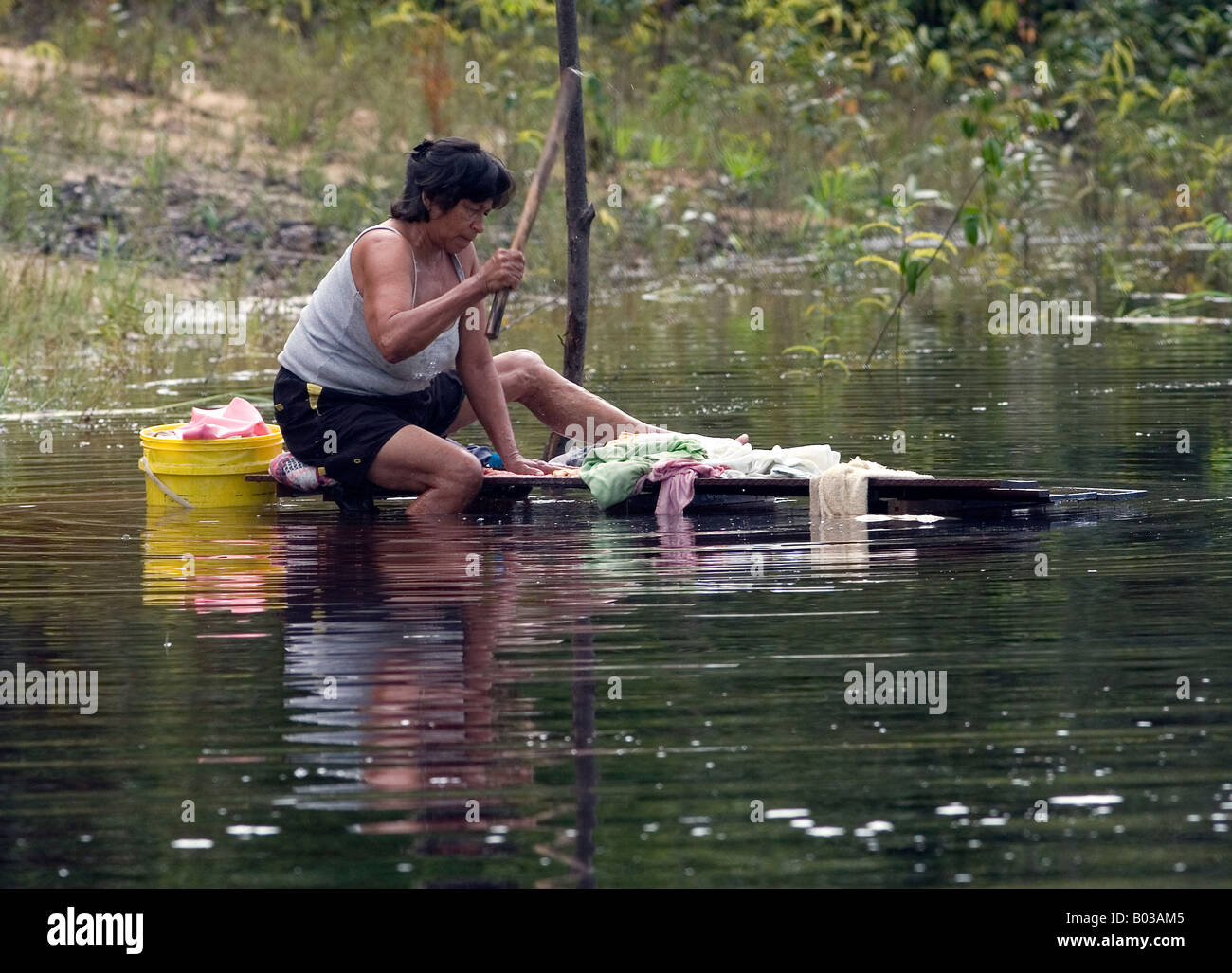 A woman washing her clothes in the river Stock Photo - Alamy